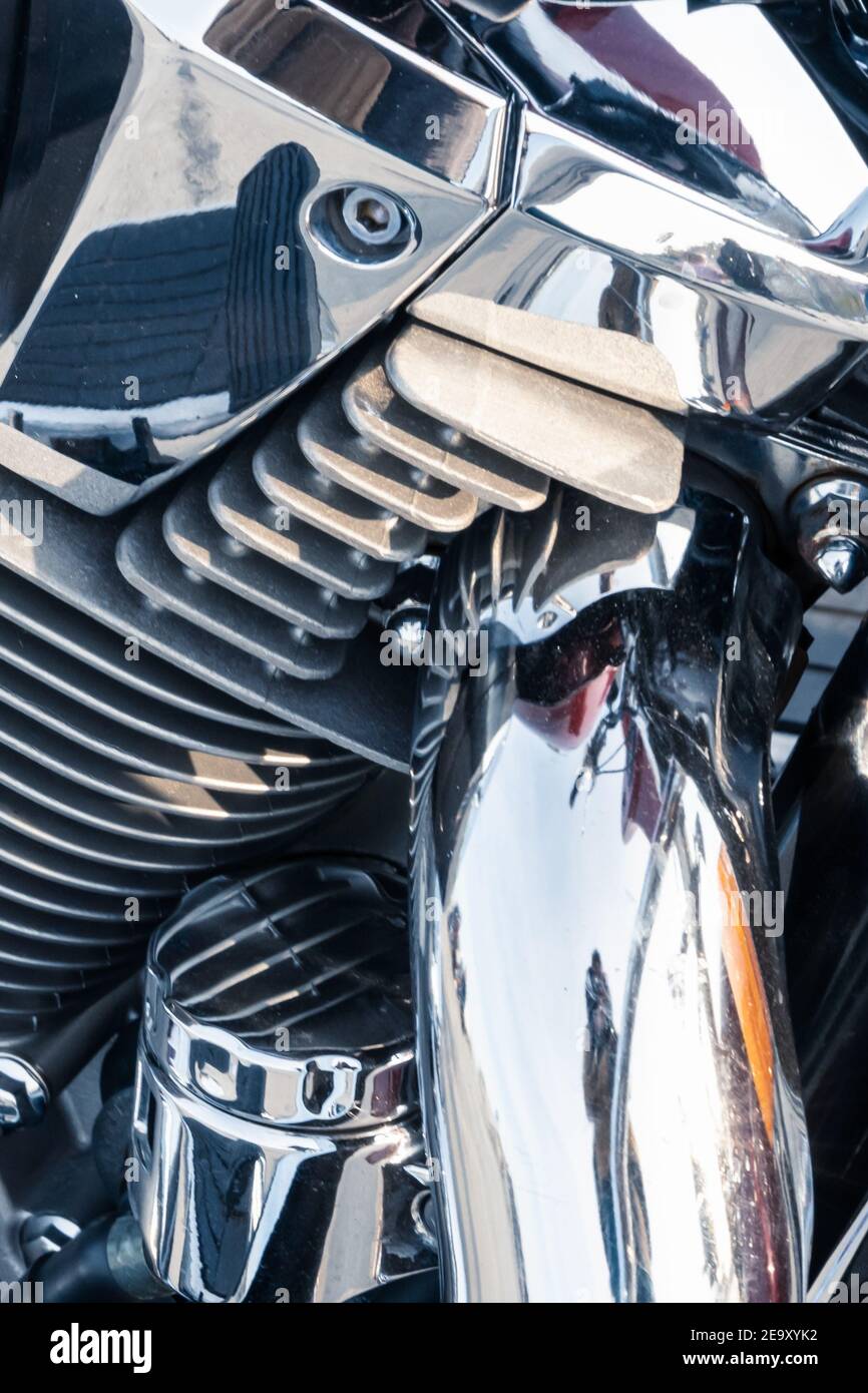 Close-up of a motorcycle engine with chrome details and reflective ...