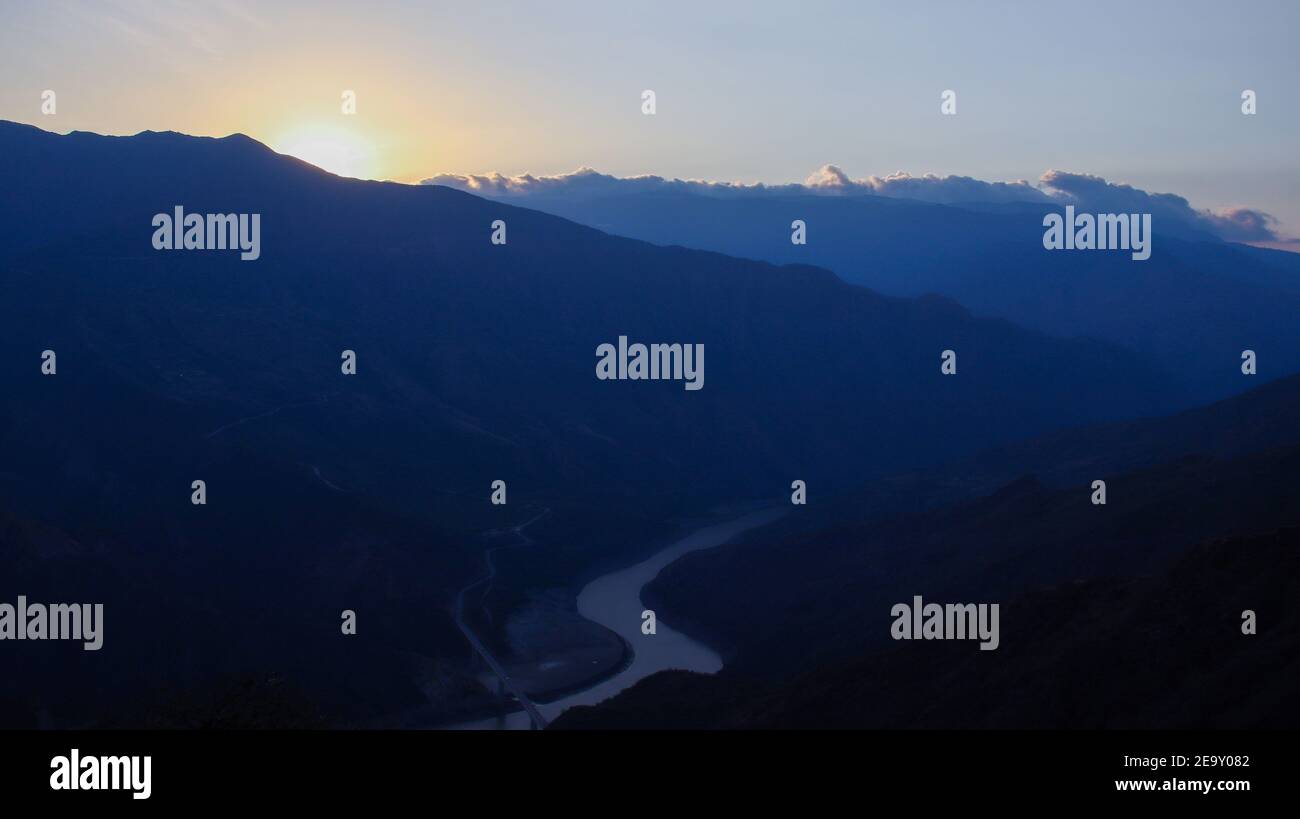 River flowing between scenic hills during sunrise Stock Photo - Alamy