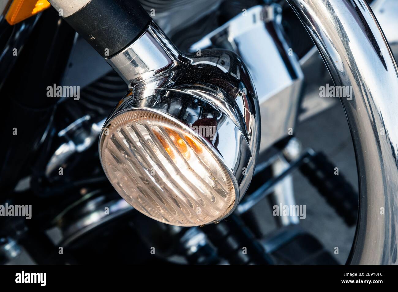 The headlight of a powerful road bike with a shiny chrome reflective ...