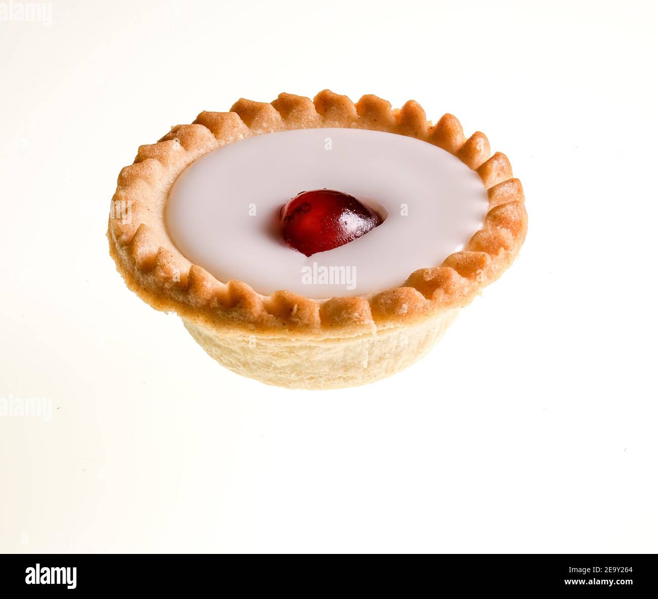 A sweet and tasty individual cherry Bakewell tart isolated on a white ...