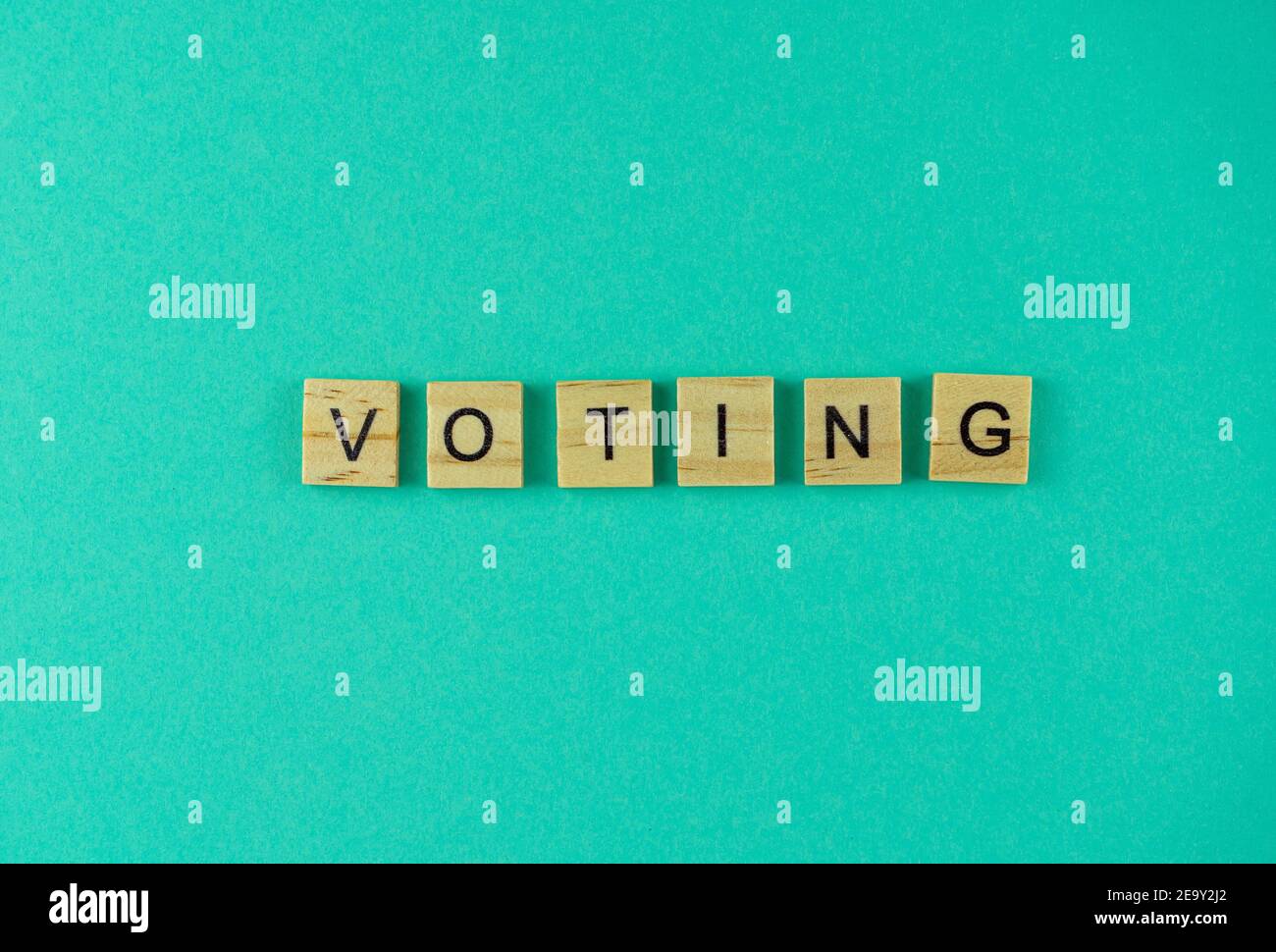 Word voting. The phrase is laid out in wooden letters. Top view. Blue ...