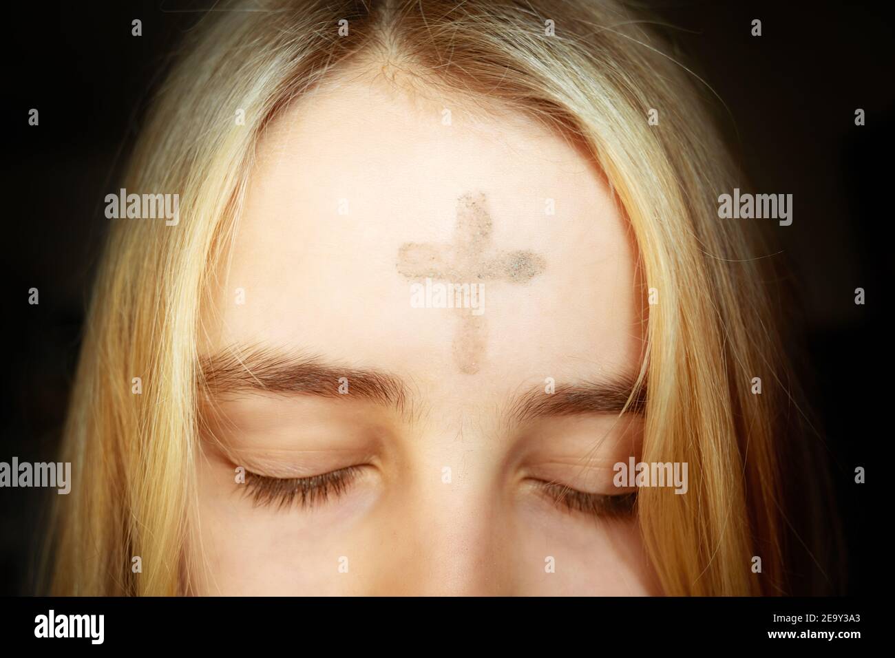 Girl with cross made from ash on forehead. Ash wednesday concept Stock ...