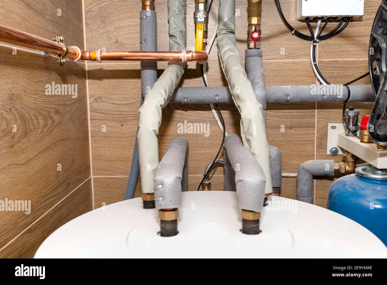 Water tank and gas pipes for a modern gas boiler in a home boiler room ...