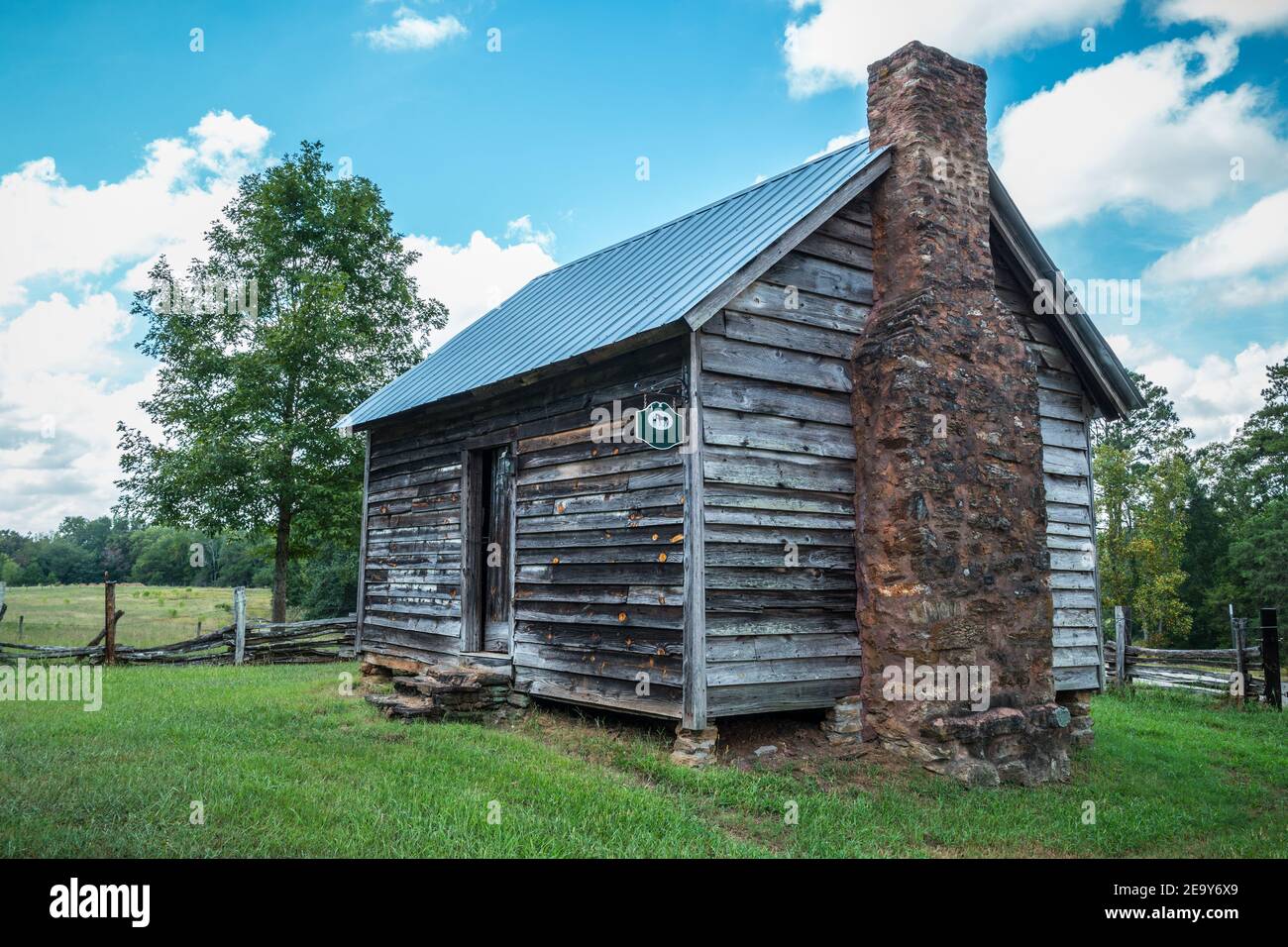 A picturesque setting of an old farm homestead roadside in a farm field ...