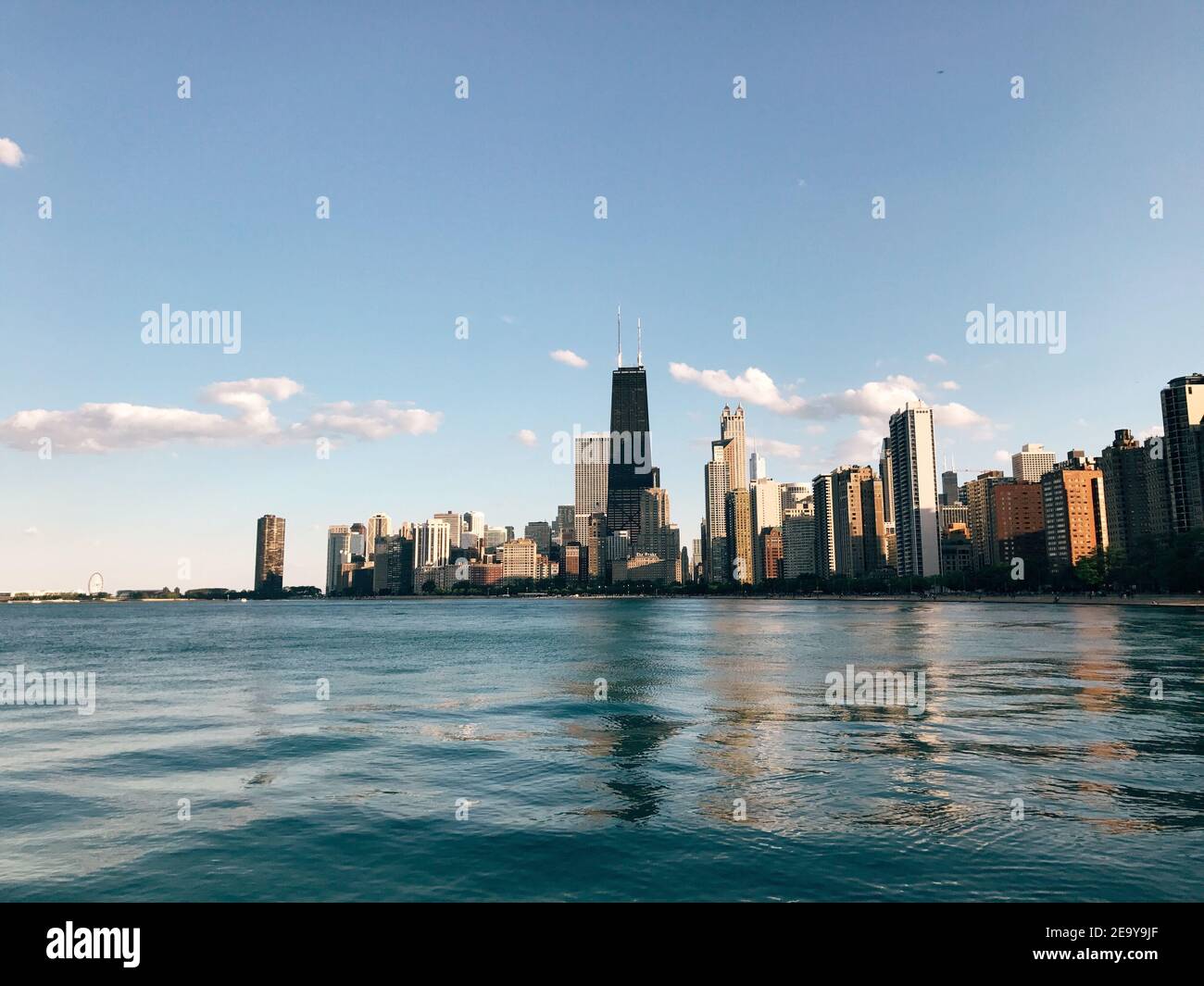 Waterfront city skyline of modern high-rise buildings with reflections ...