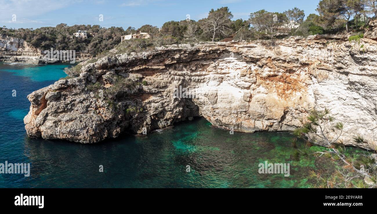 Waves crashing the rocky coast of Majorca mountains in the background ...