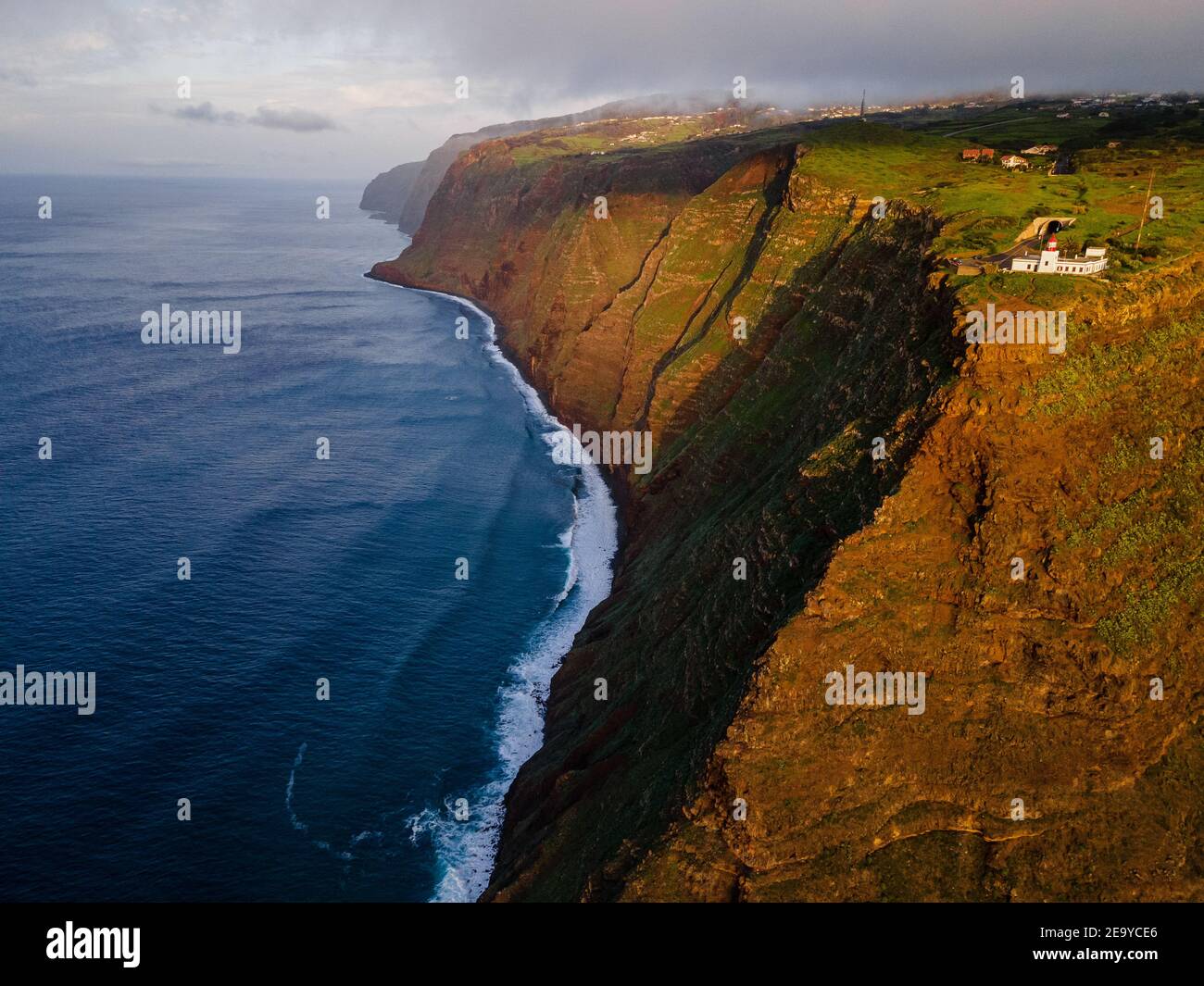 The cliff lighthouse Ponta do Pargo on the cliff coast of the Island of ...