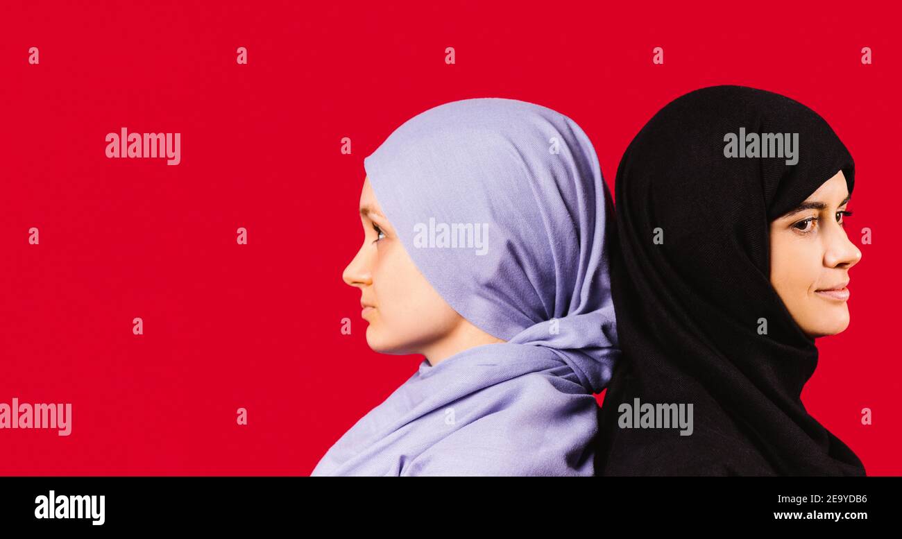 Banner- long format. Portrait of young muslim women posing on red ...