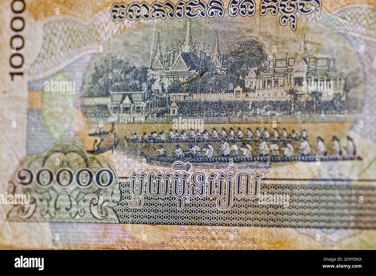 A Cambodian banknote for 10,000 Riels showing a water festival in front ...