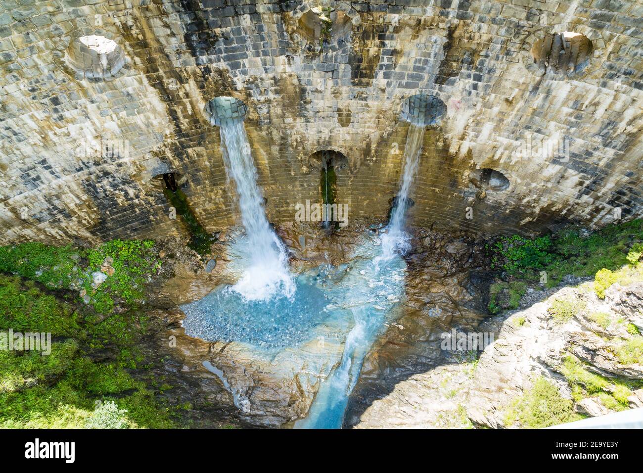 High angle shot of water cascading from dam drain holes Stock Photo - Alamy