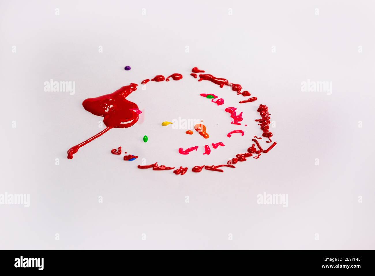 Colors drop onto a spinning white background. The color of the drops is ...