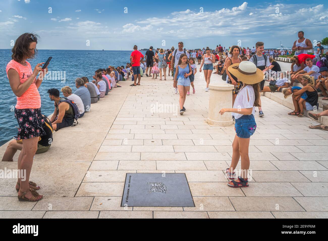 Zadar, Croatia, July 2019 Crowd of tourists listen to Sea organ, Morske ...