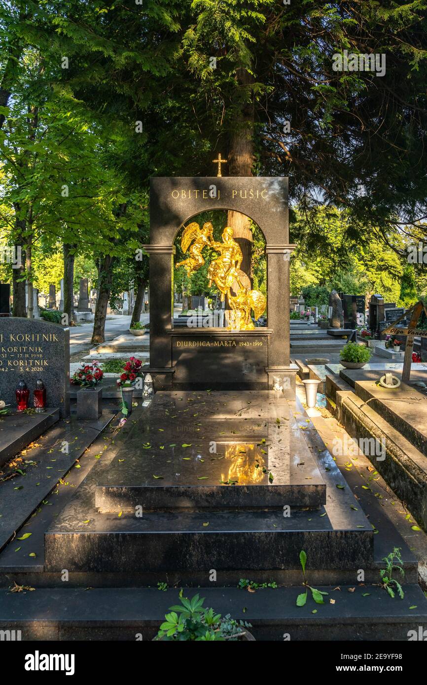 Zagreb, Croatia - Aug 9, 2020: Marble grave with golden statue in ...