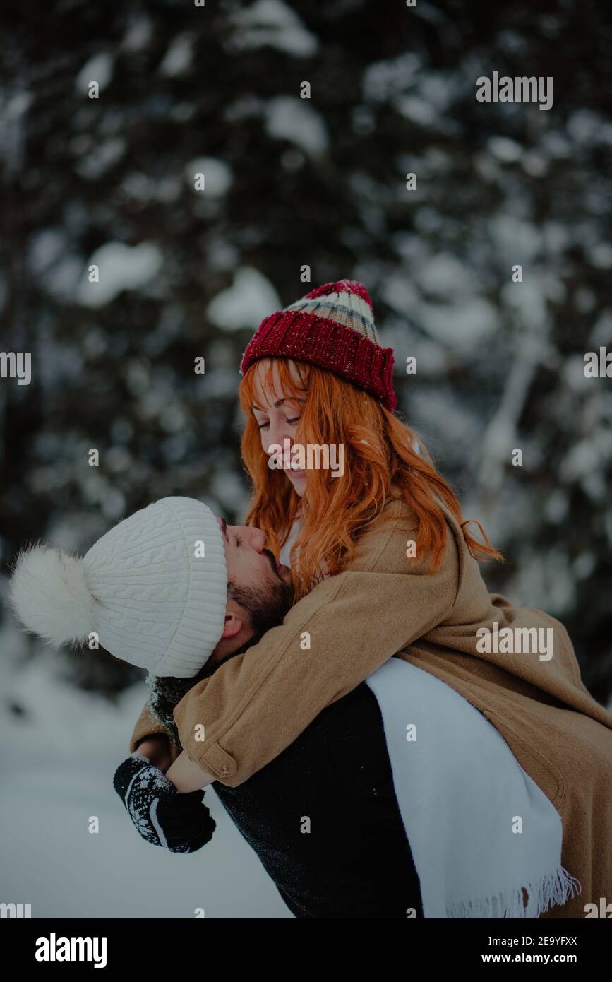 Beautiful view of the boy lifting and hugging his girlfriend at the ...