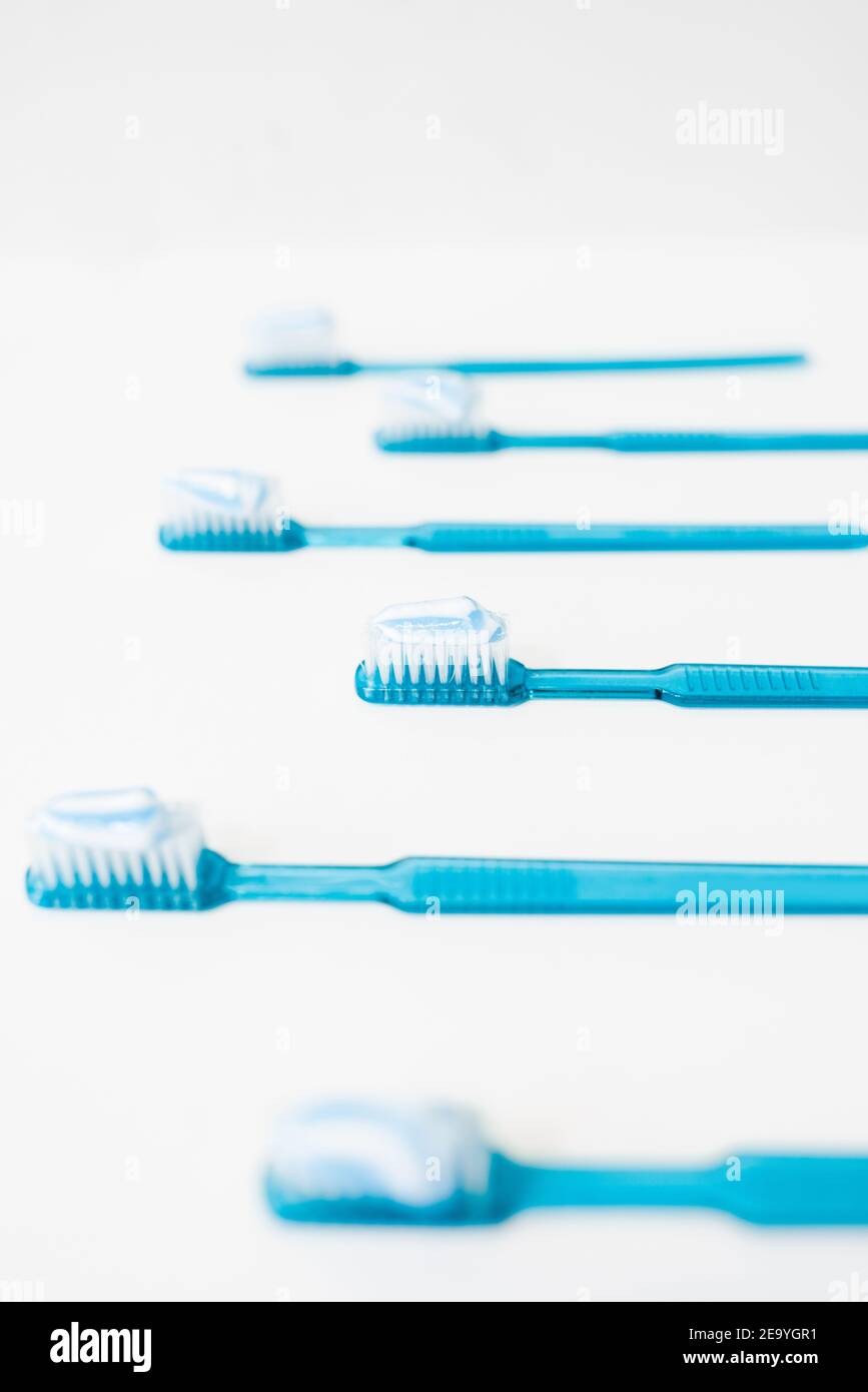 Plastic blue toothbrushes with toothpaste isolated on a white ...
