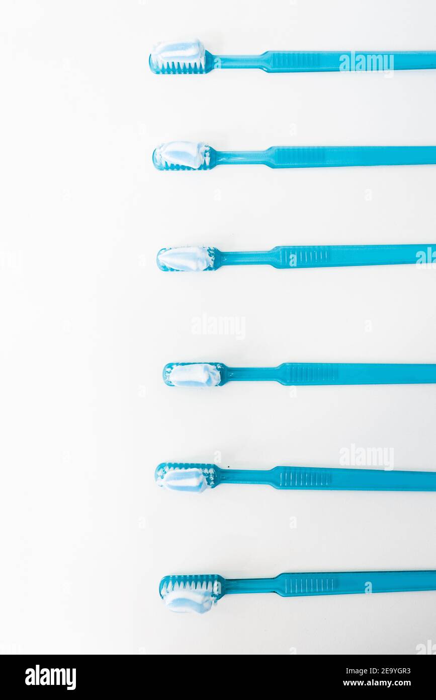 Plastic blue toothbrushes with toothpaste isolated on a white ...
