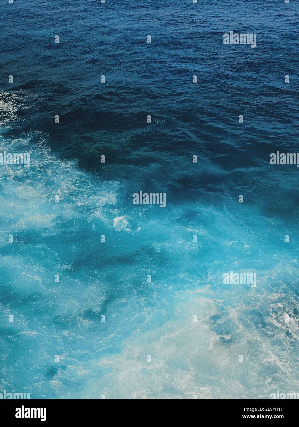 Aerial top view of waving shiny seawater in two different colors Stock ...