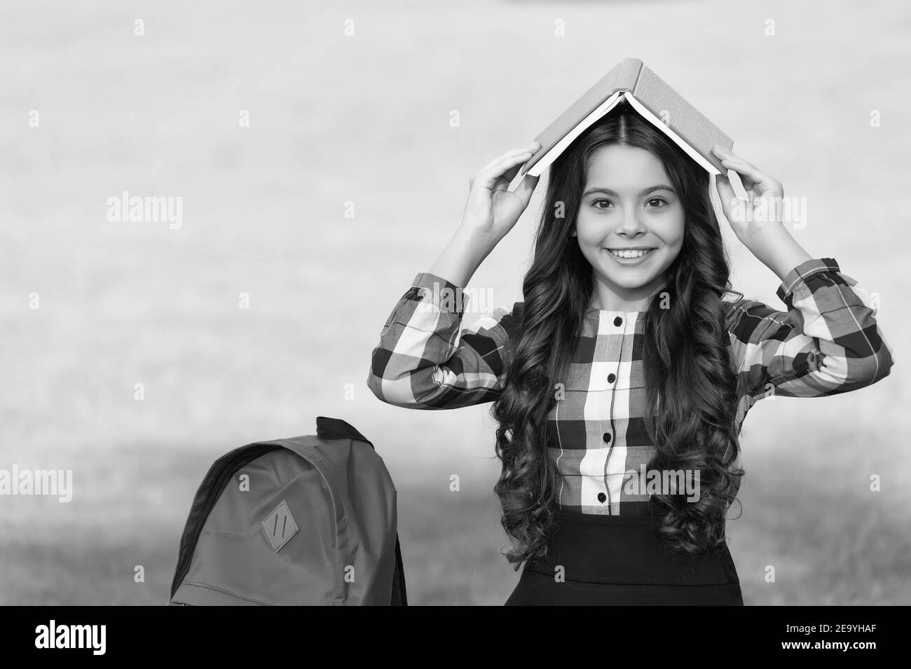 Building knowledge base. Happy child hold book on head. Knowledge day ...