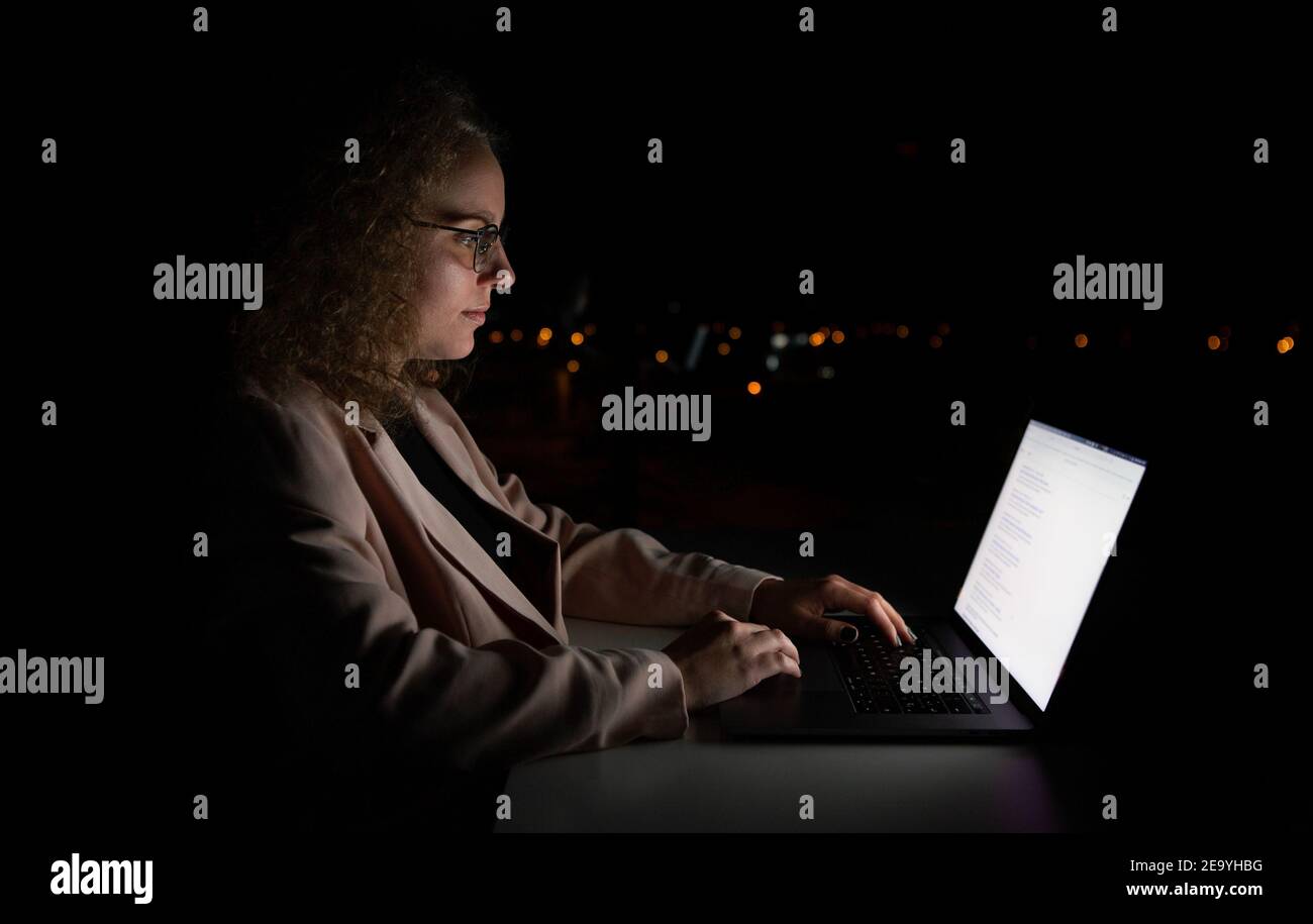 Woman in suit working at night. Concept of overwork in the office, it ...