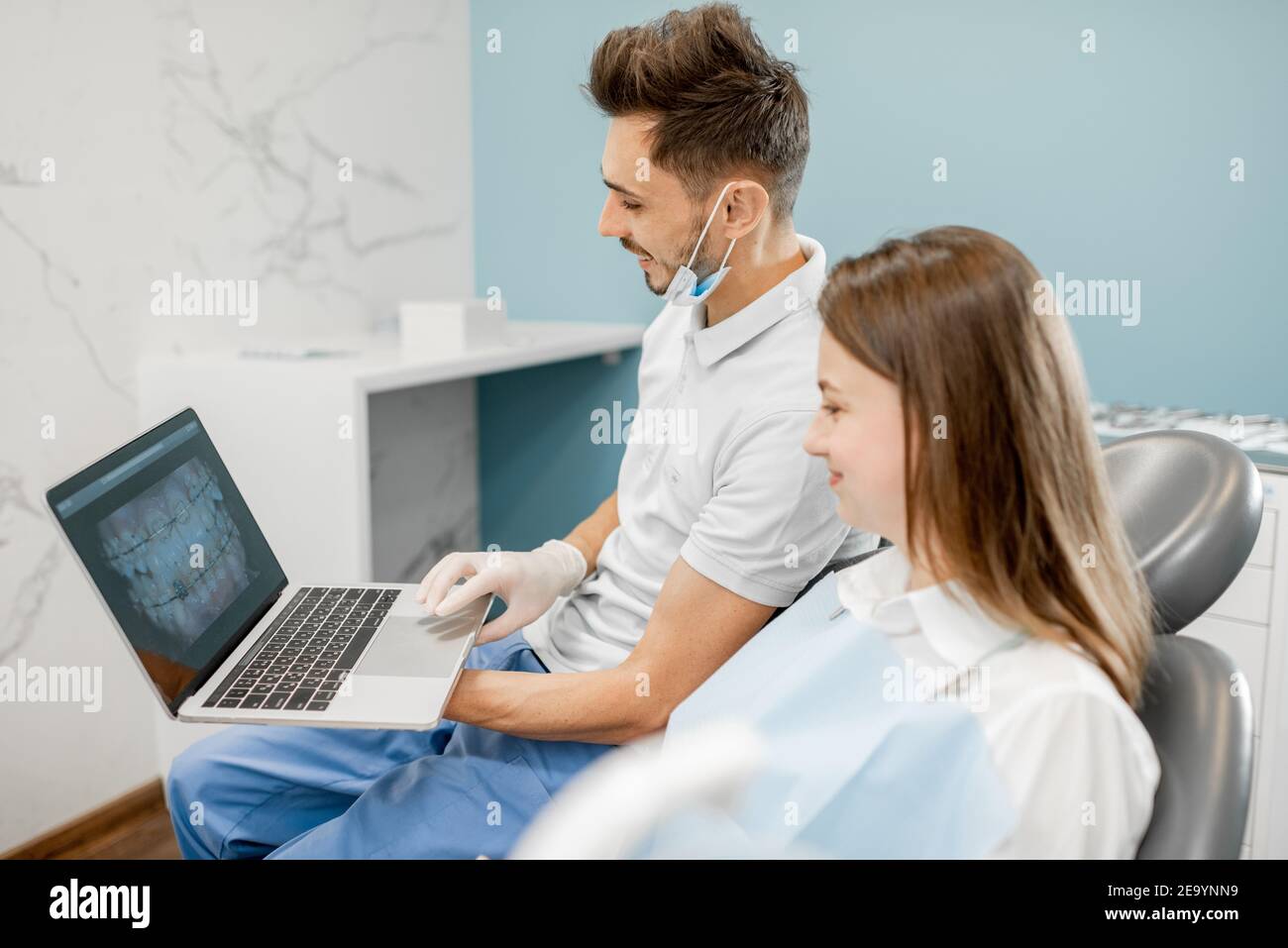 Dentist showing photo of teeth on a monitor for a young patient Stock ...
