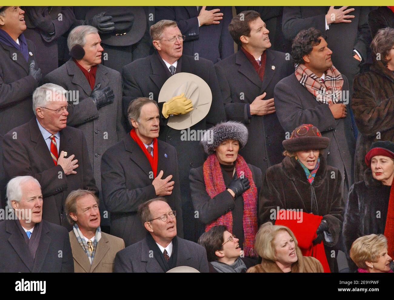 The gathered crowd recites the Pledge of Allegiance, during ...