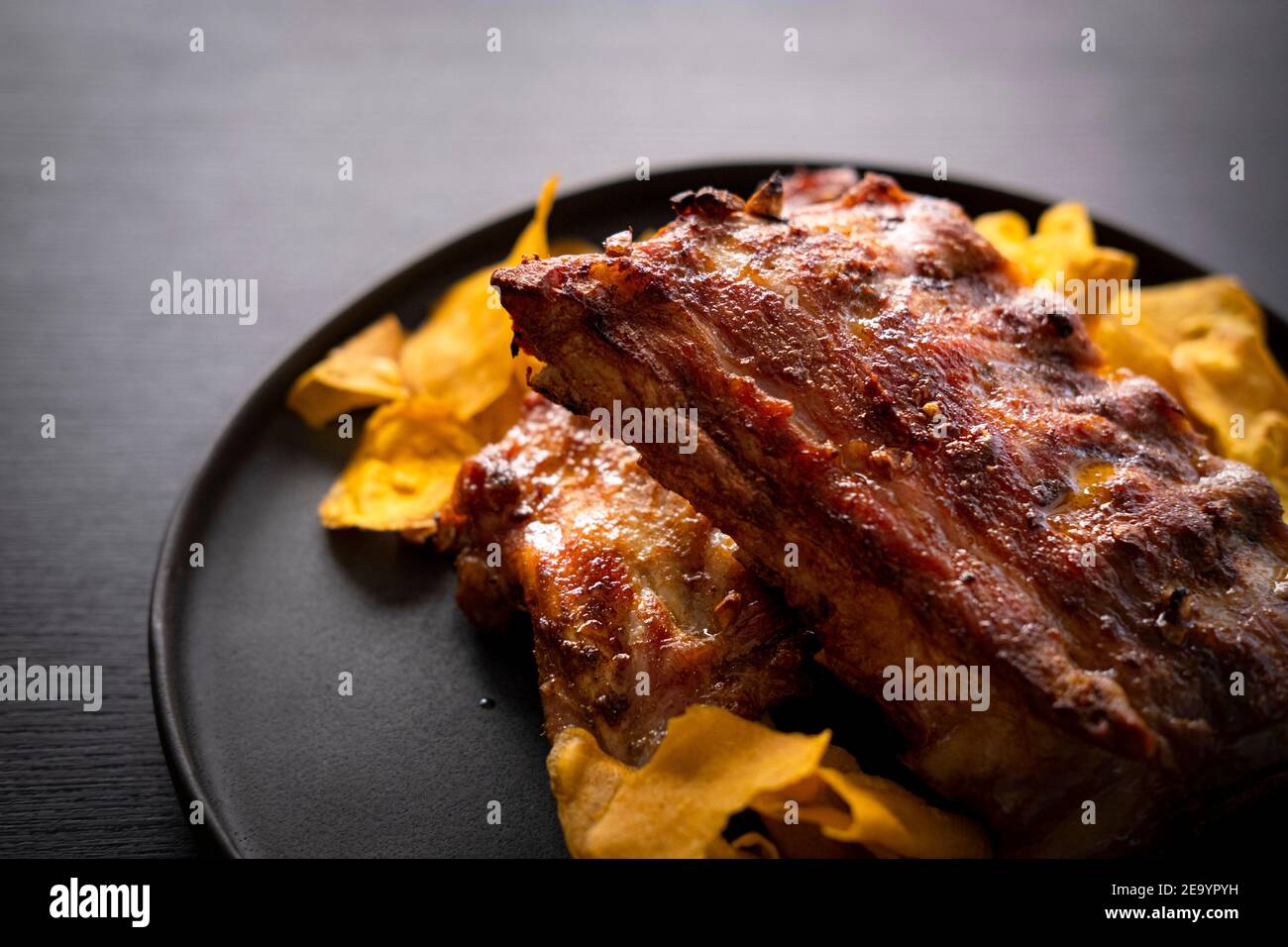Roasted ribs with sweet potato chips Stock Photo - Alamy
