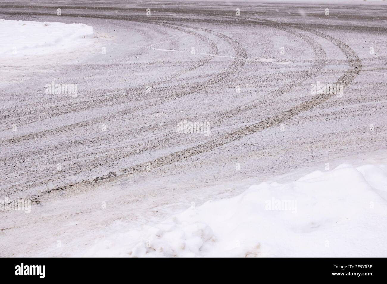 Snow and car wheel marks on the road close up Stock Photo - Alamy