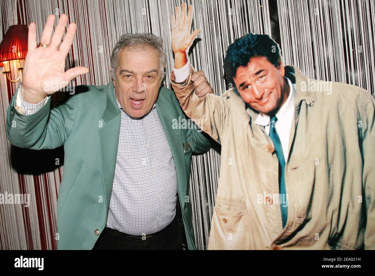 French journalist Michel Chevalet poses by a picture of Peter Falk ...