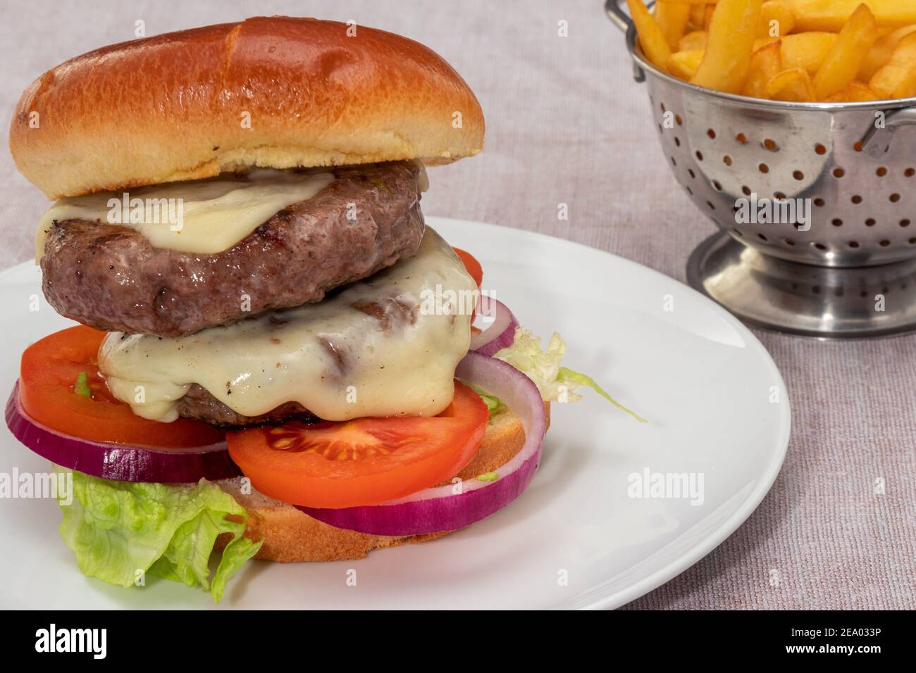 Double cheeseburger with fries Stock Photo - Alamy