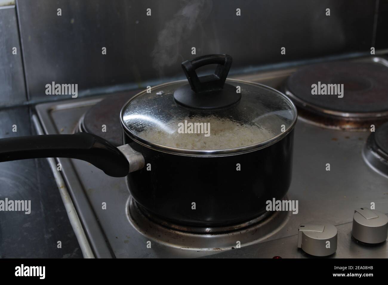 Rice cooking in pot with steam Stock Photo - Alamy