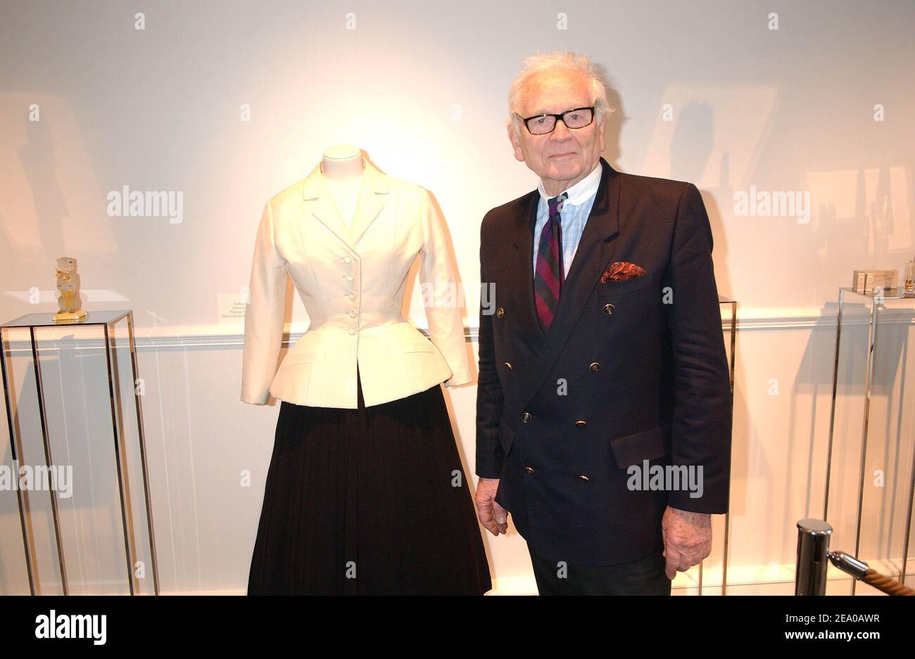 French fashion stylist Pierre Cardin poses beside items on display ...