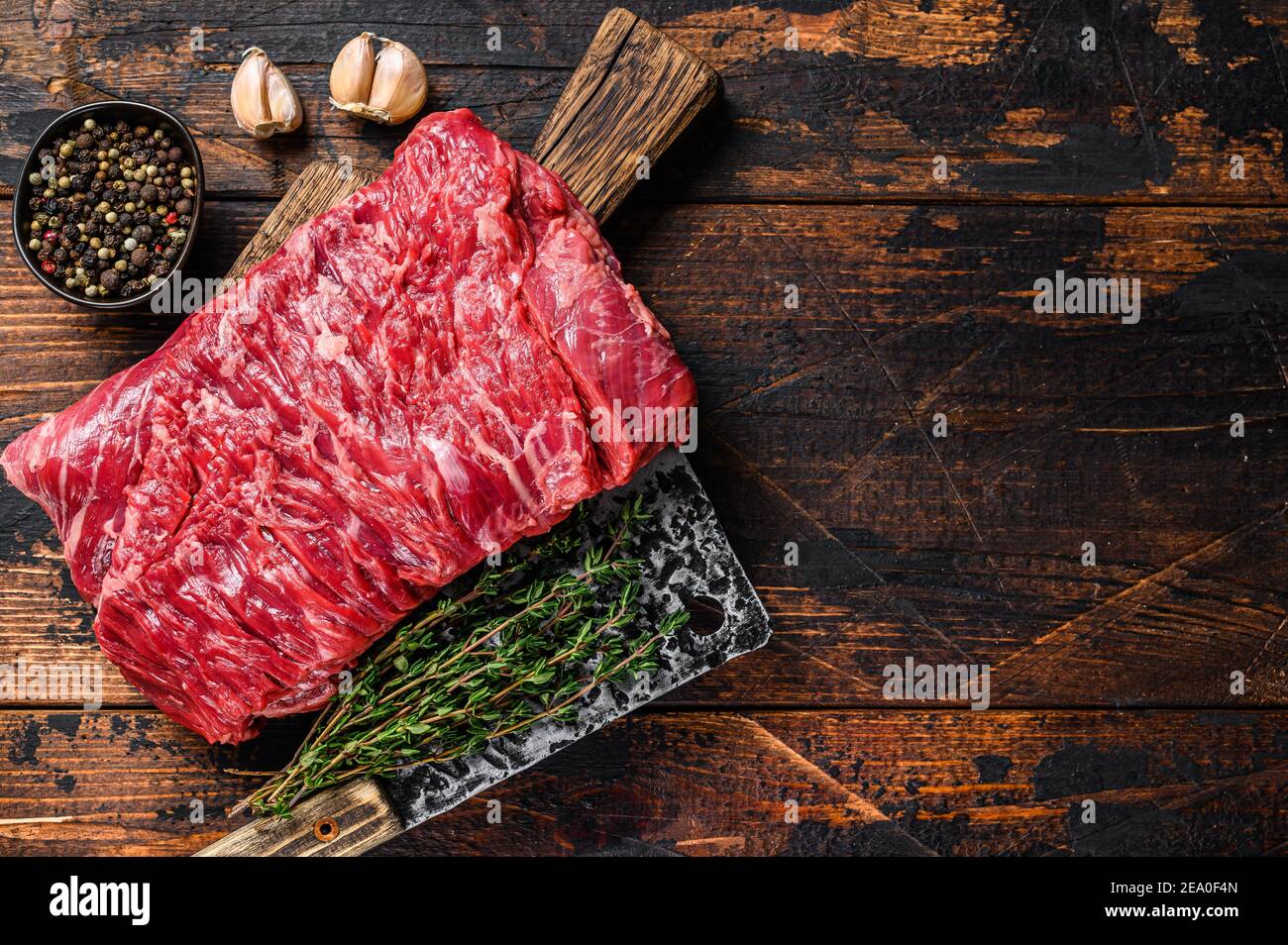 Big piece of raw beef brisket cut meat with herbs and butcher cleaver ...