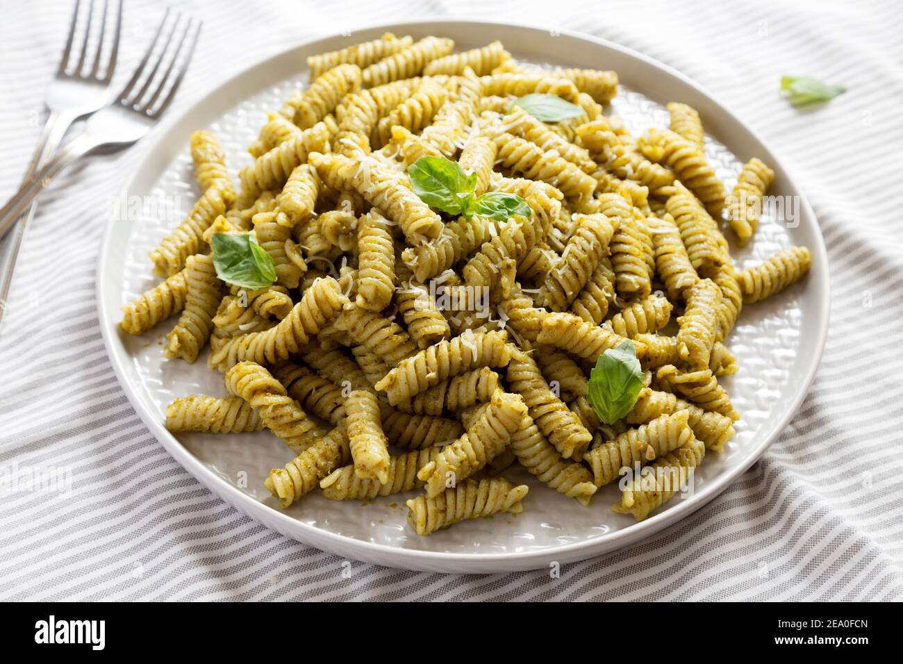 Homemade Pesto Twist Pasta on a plate, side view. Close-up Stock Photo ...