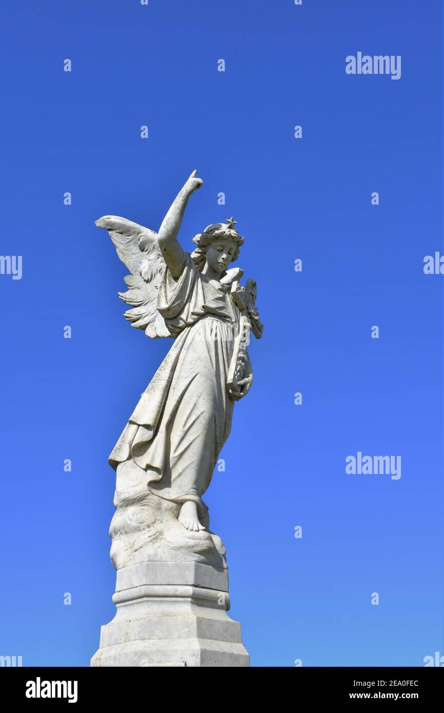 Angel statues in a California Catholic public cemetery with open sky ...