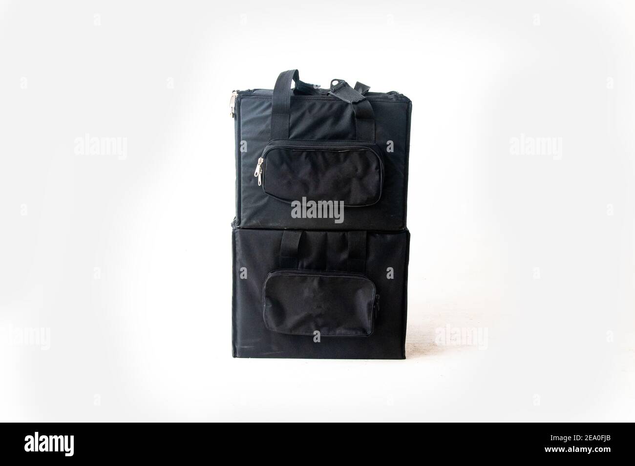 Closeup shot of black luggage bags stack on each other with a side ...