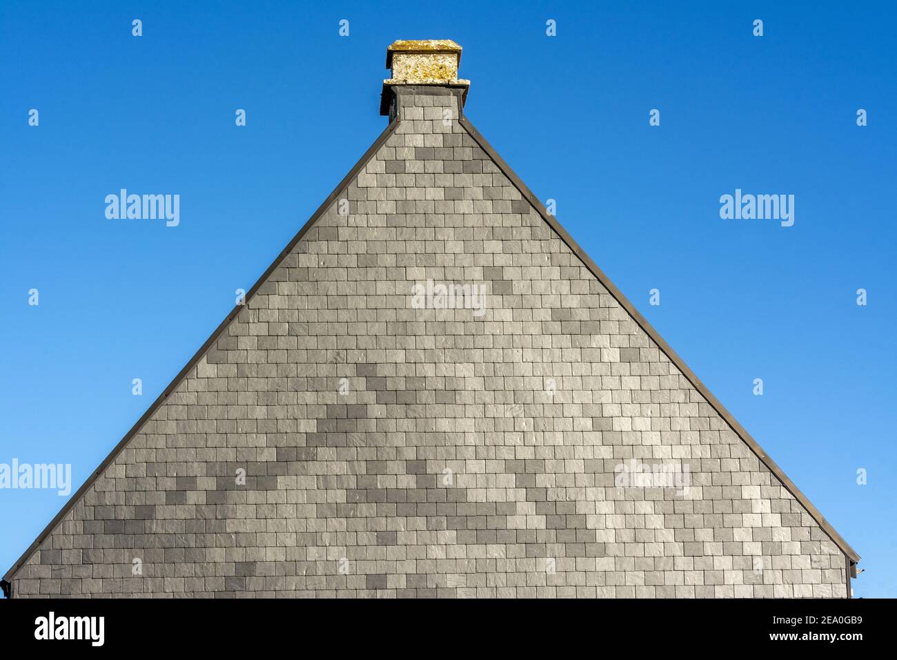 Closeup shot of a Slate roof and fireplace in a triangular shape in the ...