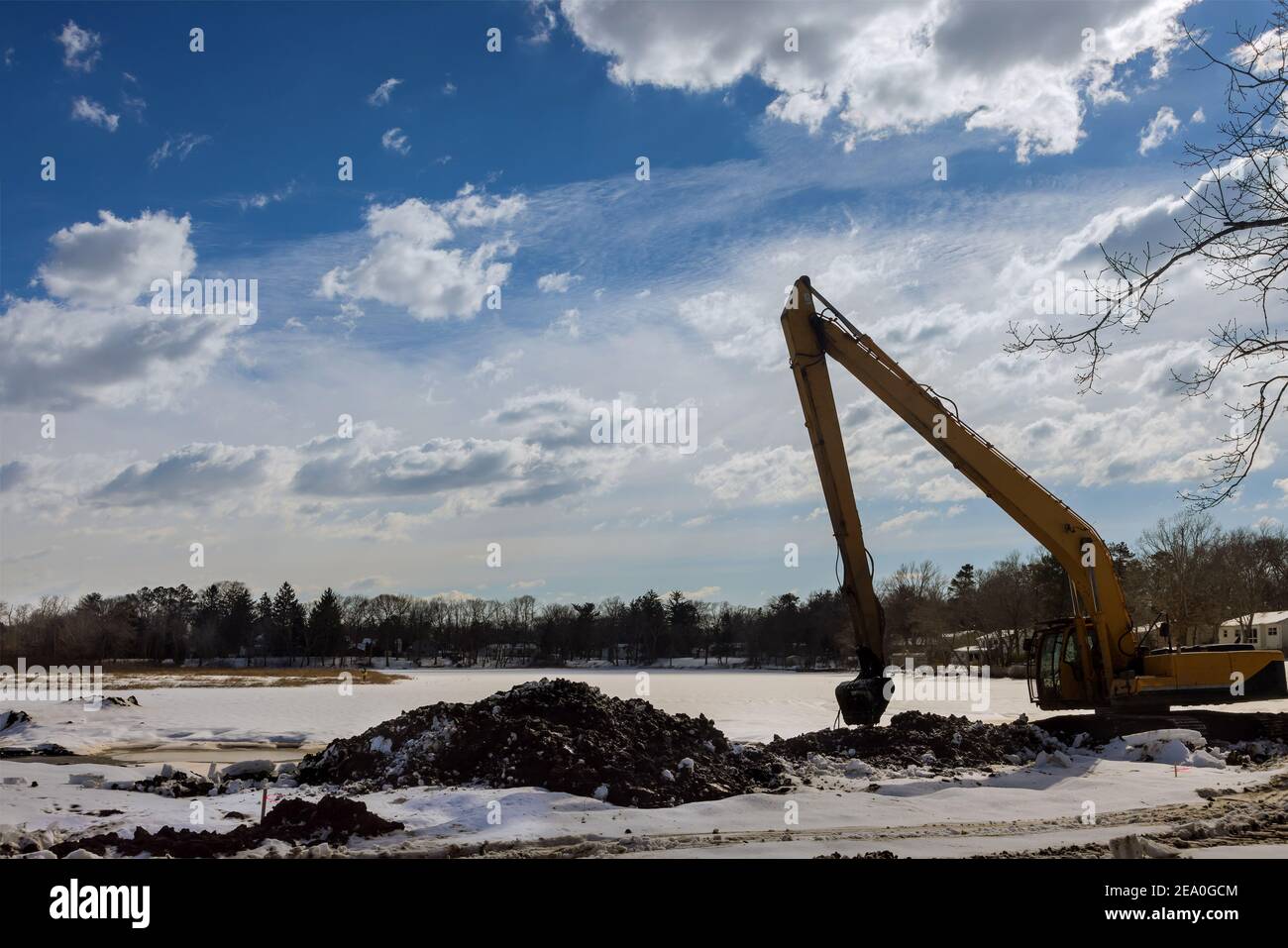 View from of the backhoe was digging a pit in the ground on winter ...