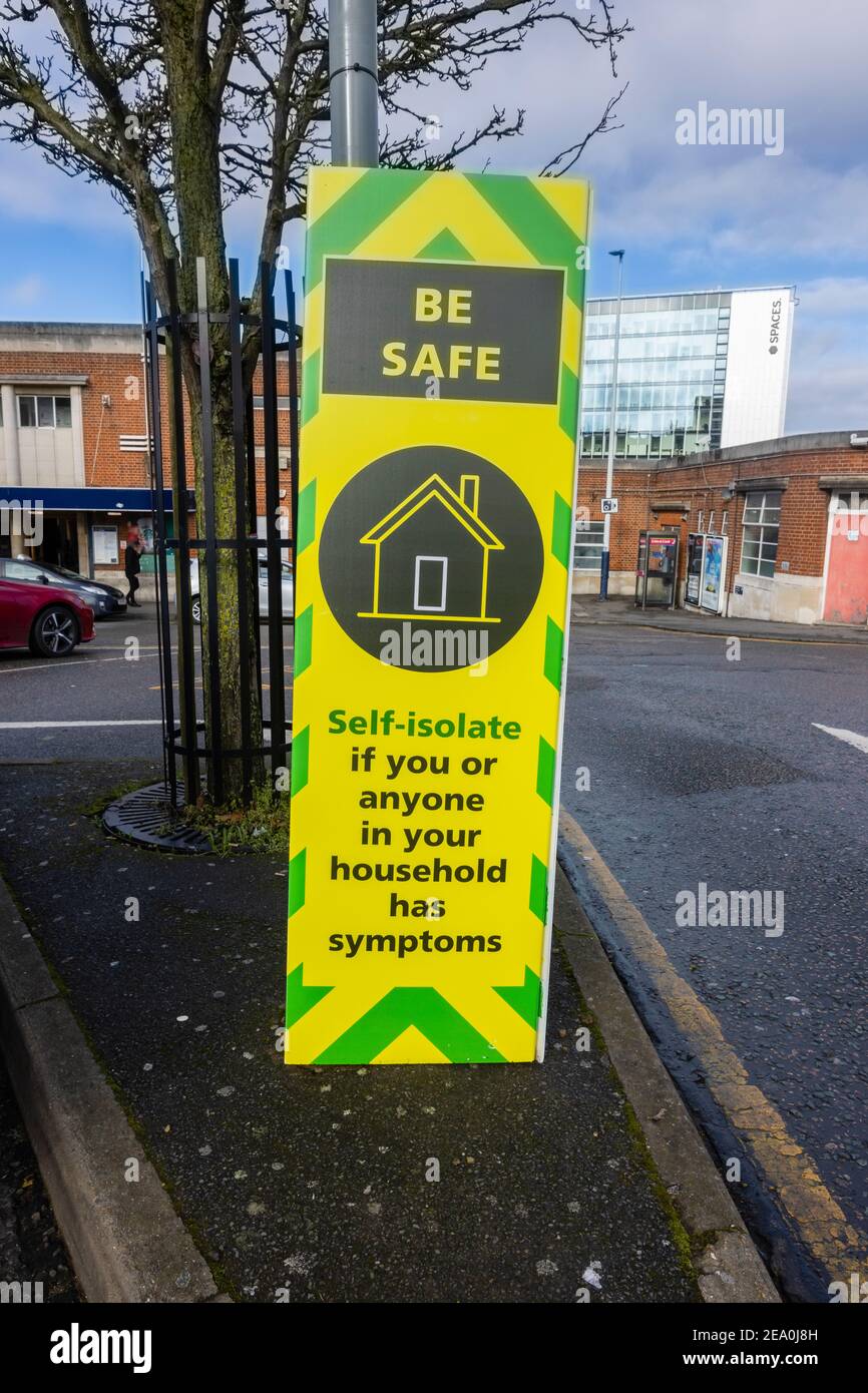 Sign with instructions to self-isolate if anyone has symptoms in Woking ...