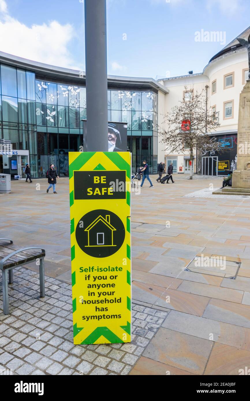 Sign with instructions to self-isolate if anyone has symptoms in Woking ...