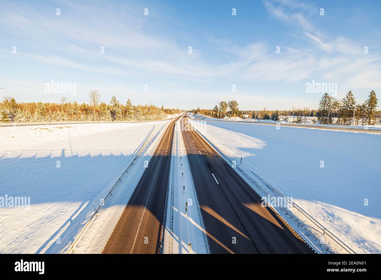 Beautiful view from above on winter highway road. Side fields covered ...
