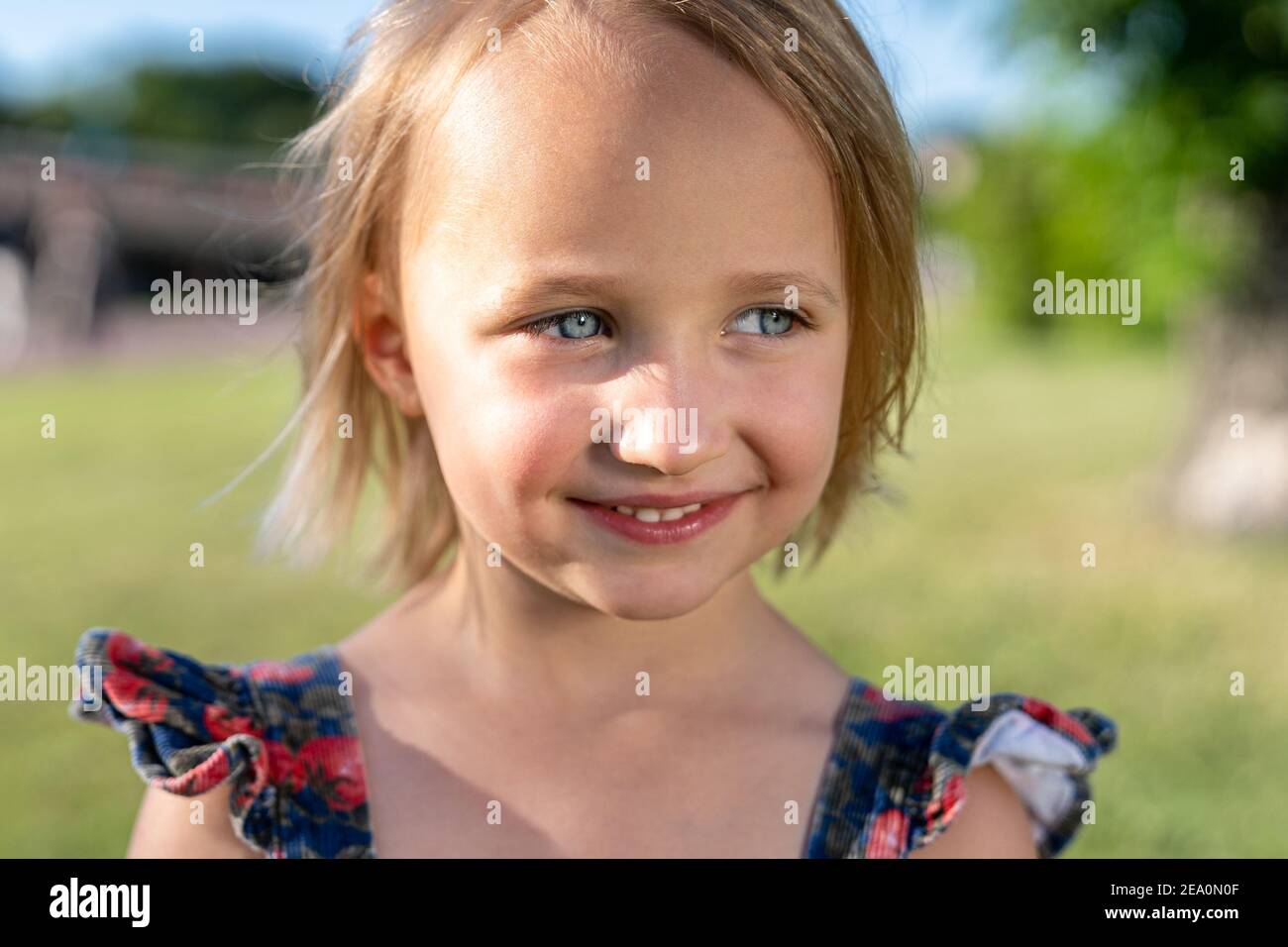 Close up portrait of smiling pretty little child girl with blue eyes ...