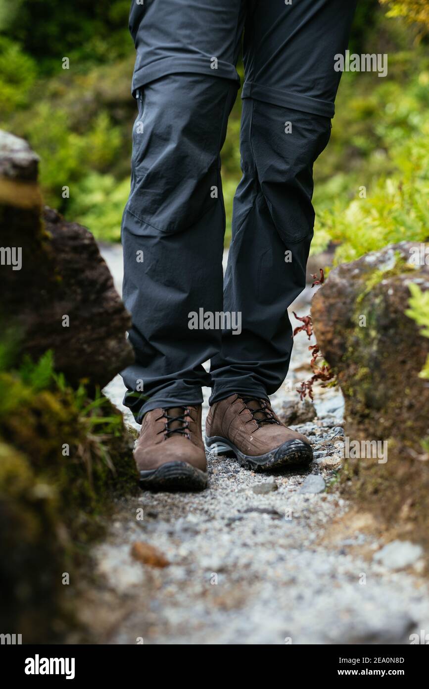 A vertical shot of man's legs in hiking shoes Stock Photo - Alamy