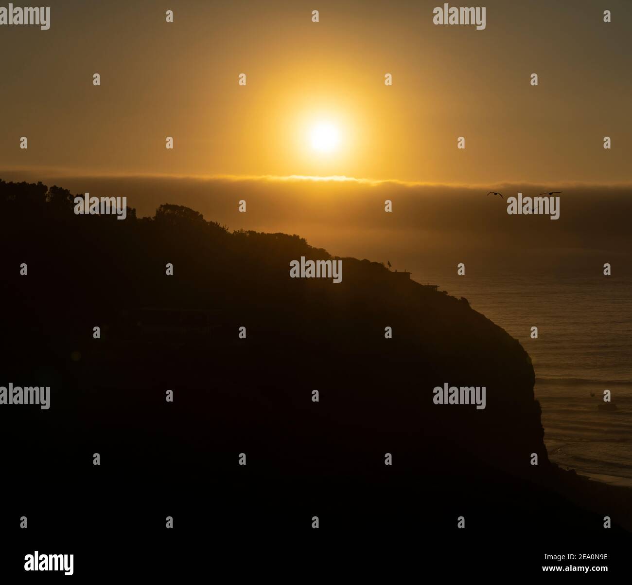 An idyllic view of the sun during sunset time on an idyllic beach with ...