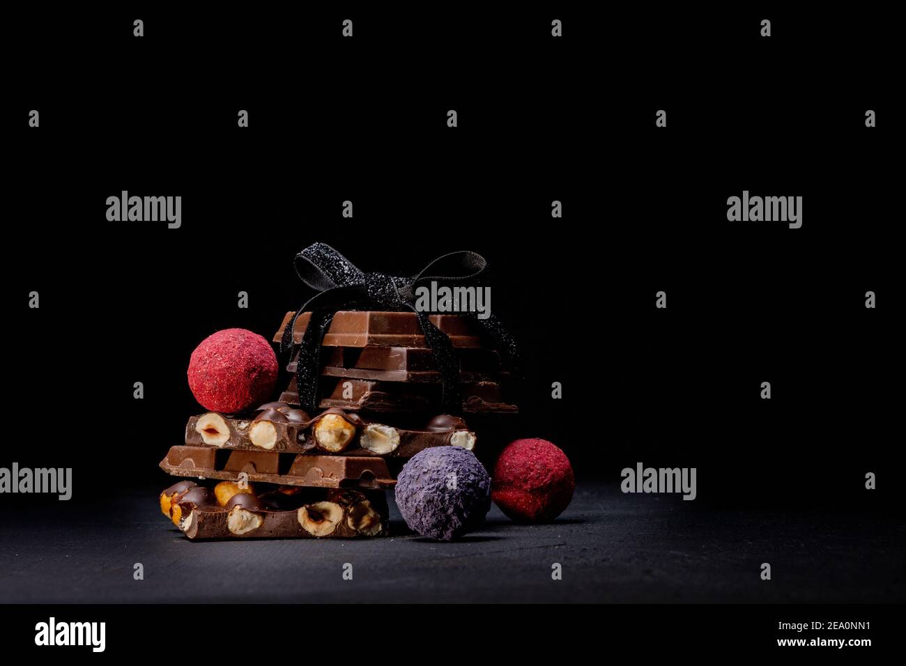 Chocolate candy truffle with chocolate pieces and flying cocoa powder ...