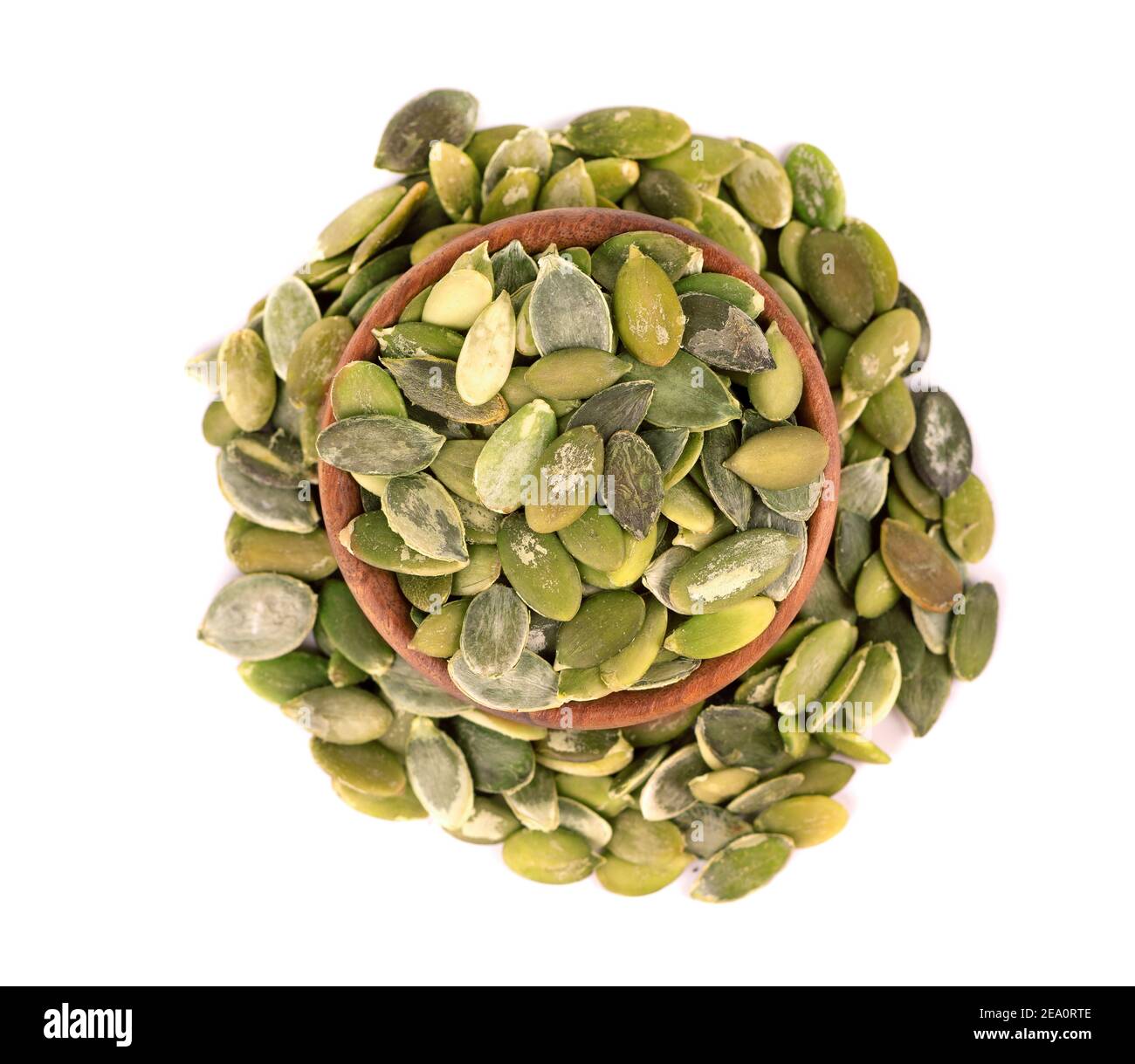 Pumpkin seeds in wooden bowl, isolated on white background. Green ...