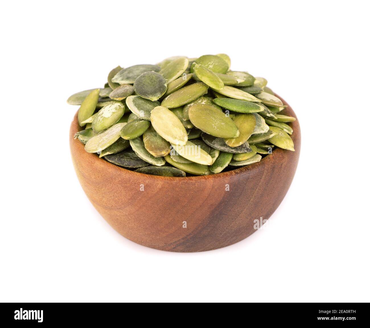 Pumpkin seeds in wooden bowl, isolated on white background. Green ...