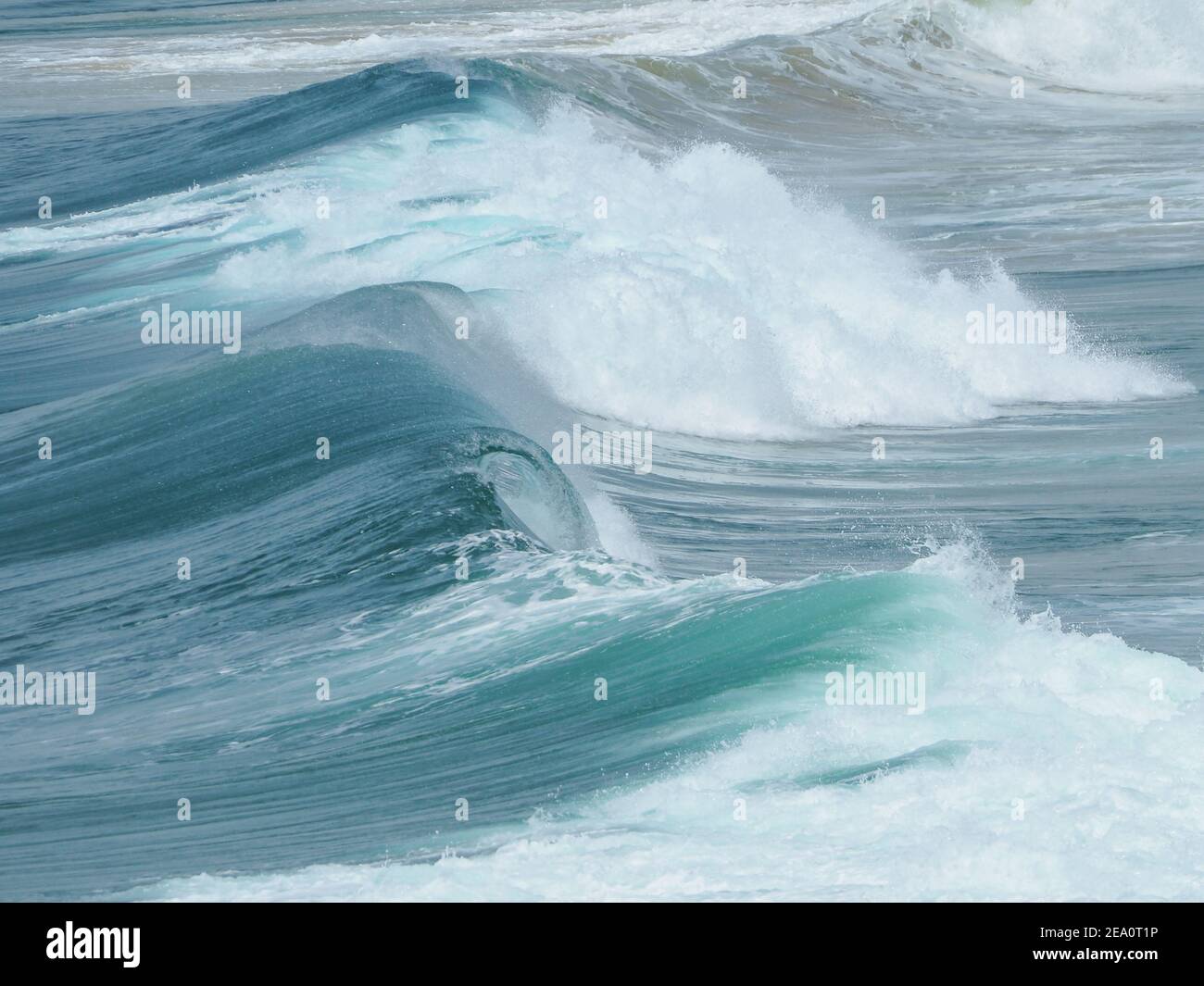Majestic ocean waves rolling in and breaking, blue and foamy white ...