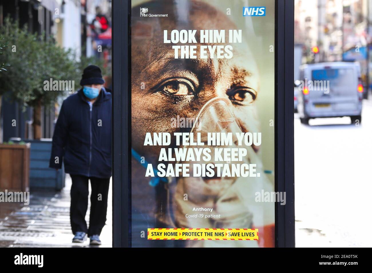 London, UK. 02nd Feb, 2021. A man wearing a face mask walks past a ...