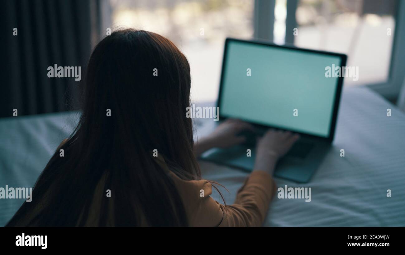 woman lying on bed working in front of laptop at home internet Stock ...