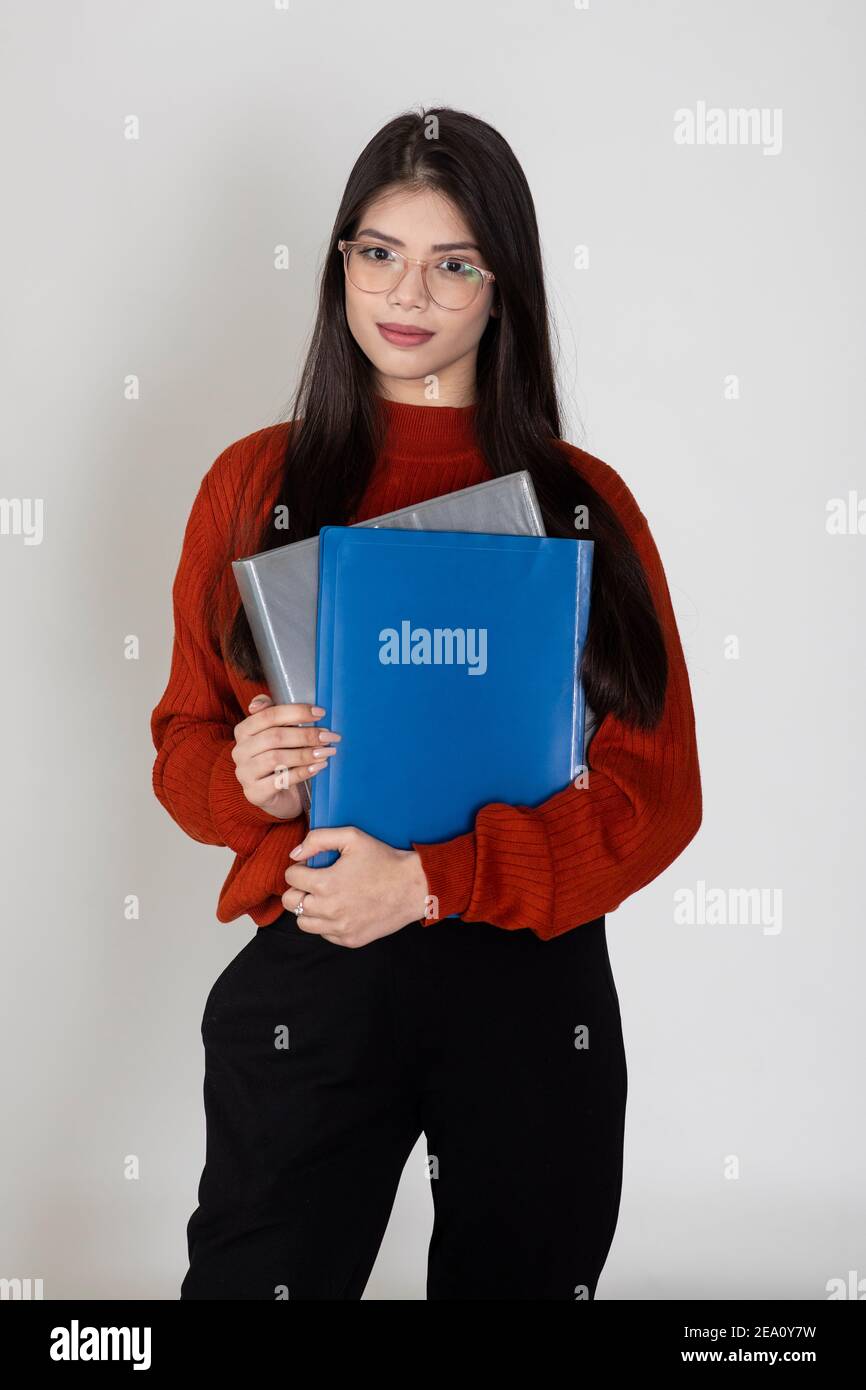 Portrait of a beautiful young lady wearing spectacles and holding ...